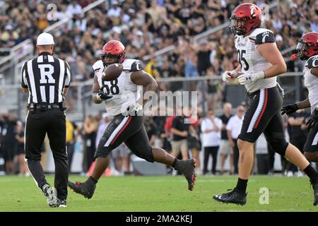 Cincinnati defensive lineman Dontay Corleone (58) completes a sack of ...