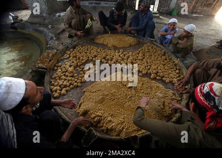 Pakistani farmers boil sugarcane juice to make a traditional sweet ...