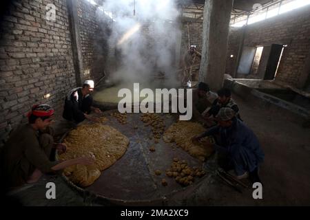 Pakistani farmers boil sugarcane juice to make a traditional sweet ...