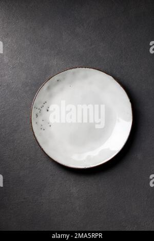 Top view of black empty plate on marble stone background Stock Photo ...