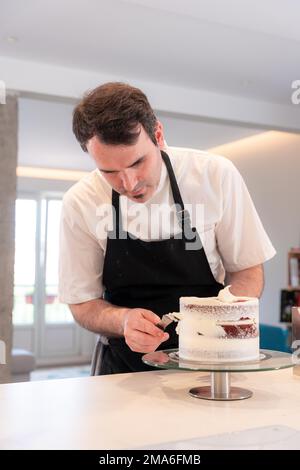 A challenger man bakes a red velvet cake at home, assembling the triple ...