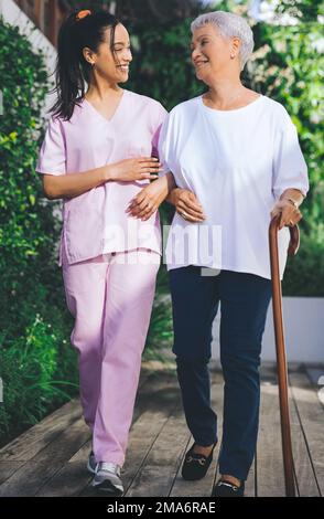Happy young woman walking and using smartphone on summer resort Stock ...