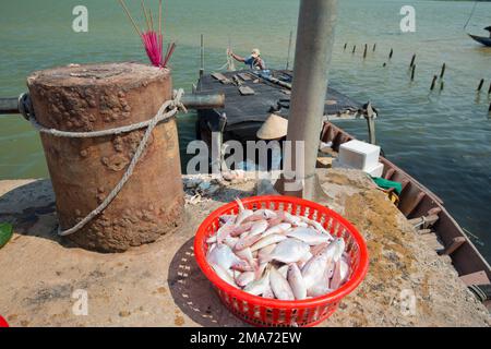 Small fishing pier on the Thu Bon River where a fishing boat is ...