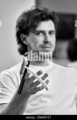barber testing the sharpness of blade before cutting Stock Photo - Alamy