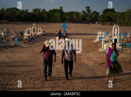 A Yaqui Indigenous family walks past the cemetery where slain water ...
