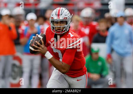 Ohio State player C.J. Stroud wearing a face mask is interviewed during ...