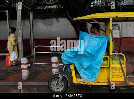 DELHI, INDIA - OCT 10: Rickshaw rider transports passenger on October ...