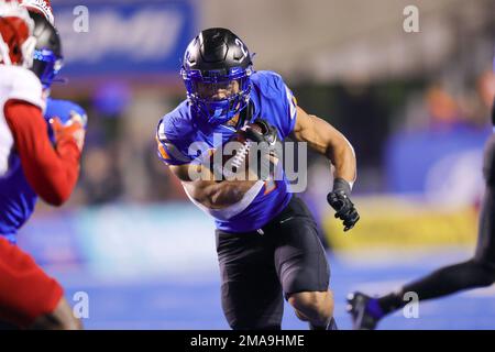 Boise State running back George Holani, front, runs by Fresno State ...