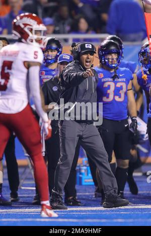 Boise State head coach Andy Avalos checks on an injured player in the ...