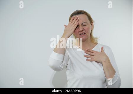 An Indian woman holding her chest for pain showing painful expression ...