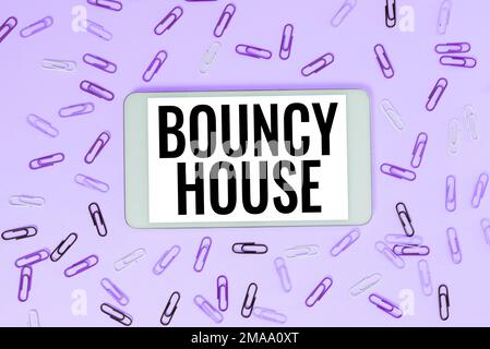 Sign displaying Bouncy House, Word for Automated program that runs over ...