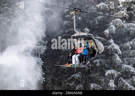 Skiers, snowboaders enjoy skiing in ski areal in Destne in Orlicke ...