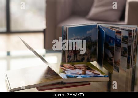 on table open photobook from photo shoot of family. preservation of ...
