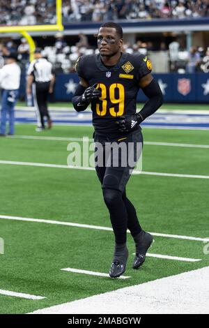 Washington Commanders safety Jeremy Reaves (39) dons a helmet with a ...