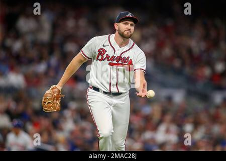 Atlanta Braves relief pitcher Dylan Lee follows through on his delivery ...