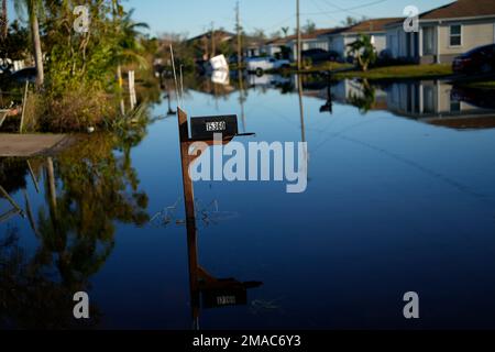 Receding flood waters still fill a street in Harlem Heights, three days ...