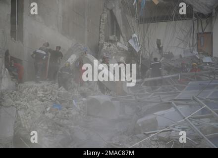 Iraqi emergency and rescue personnel search for survivors in the rubble ...