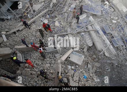 Iraqi emergency and rescue personnel search for survivors in the rubble ...