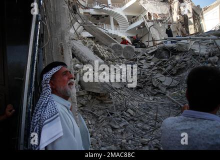 Iraqi emergency and rescue personnel search for survivors in the rubble ...