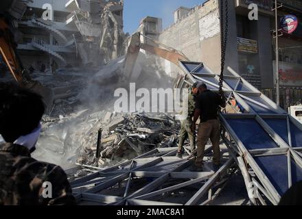 Iraqi emergency and rescue personnel search for survivors in the rubble ...