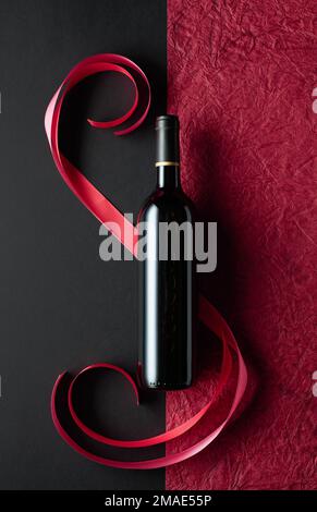 Bottle of red wine with red and pink satin ribbons. Top view Stock ...