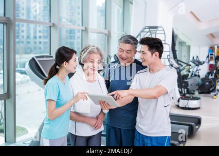 Three under the guidance of personal training in the gym for a workout ...