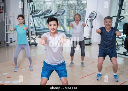 A family of four in the gym Stock Photo - Alamy
