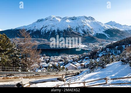 Top view of the lake and town of St. Moritz covered in snow during ...