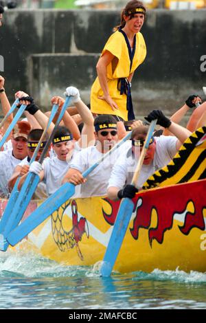 US Navy Sailors on the port side elevator move stores during a vertical ...