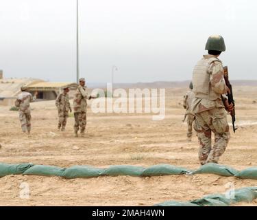 An Iraqi Army soldier conducts tactical training alongside an M1 Abrams ...