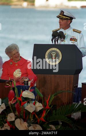 First lady Barbara Bush smiles standing by donkey as President George H ...