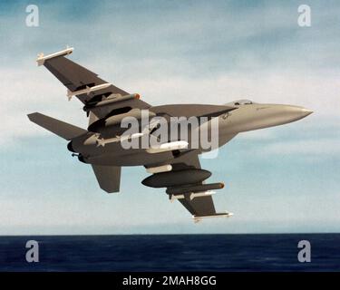 An AGM-84E SLAM stand-off land attack missile sits on a pedestal beside ...