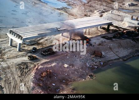 Demolished Iraqi vehicles line a roadway in the Euphrates River Valley ...