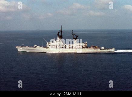 The guided missile cruiser USS BIDDLE (CG-34) passes near the bow of the nuclear-powered guided ...