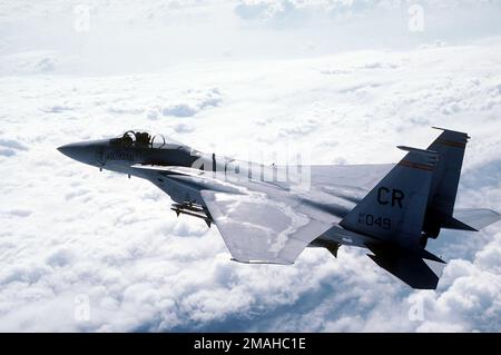 An air-to-air left side view of an F-15C Strike Eagle aircraft from the ...