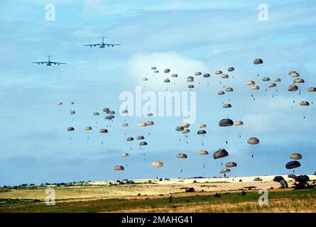 A formation of aircraft of the 82nd Airborne Division fly over a pass ...