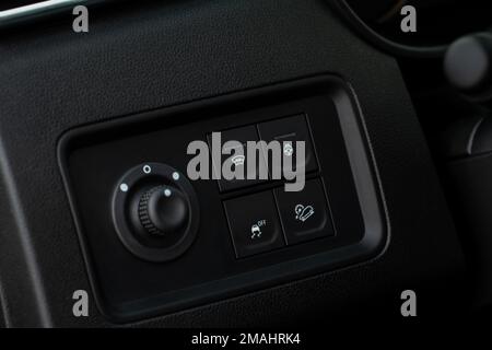 Hand operating ESP (electronic stability program) control close up view ...