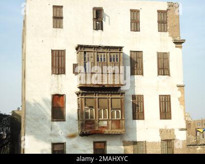 An old vintage retro building with old stye wooden balcony and windows ...