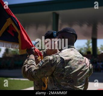 Col. Damon Wells, commander of the 4th Infantry Division Artillery passes the unit colors to ...