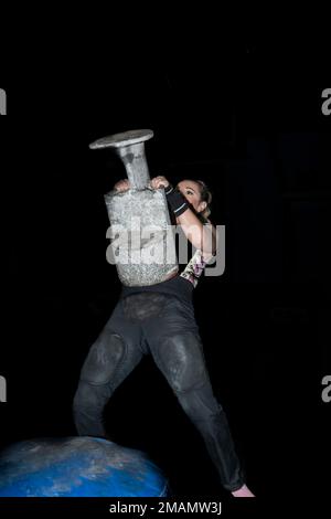 Basque stone that elevates the concept of rural sport. woman from the ...