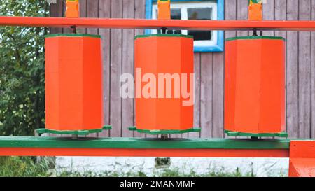Rotation of the red prayer drums outside the Buddhist temple Stock ...