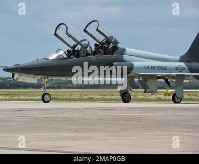 A T-38 taxis down the runway with the glass canopy open after landing ...