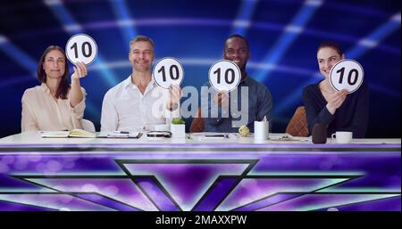 Happy Panel Judges Sitting In Front Of Red Curtain Showing 10 Score ...