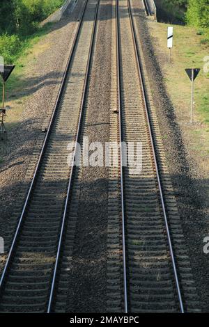 some Railroad tracks lead through a natural landscape Stock Photo - Alamy