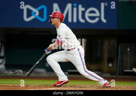Texas Rangers' Corey Seager follows through on a swing during a ...