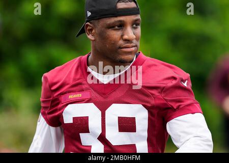 Washington Commanders safety Jeremy Reaves (39) dons a helmet with a ...