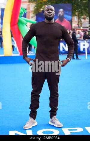 Stormzy poses for photographers upon arrival at the GQ Men of the Year ...