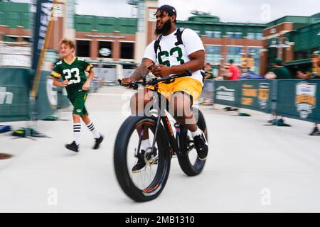 Green Bay Packers' Rasheed Walker takes a selfie as he rides a bike to ...