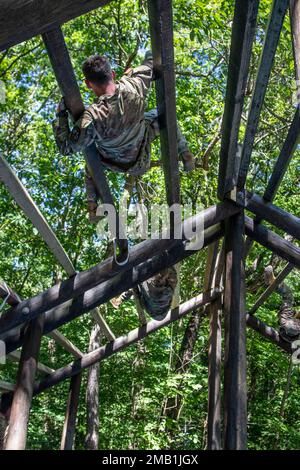Cadets climb up the weaver obstacle on the obstacle course on Fort Knox ...