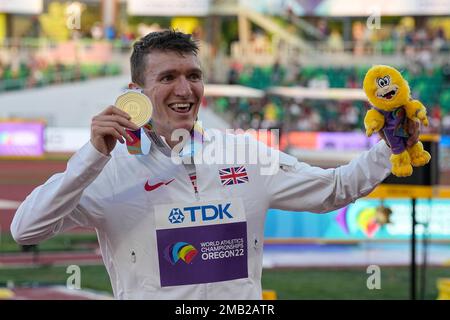 Gold medalist Jake Wightman, of Britain, poses on the podium after the ...